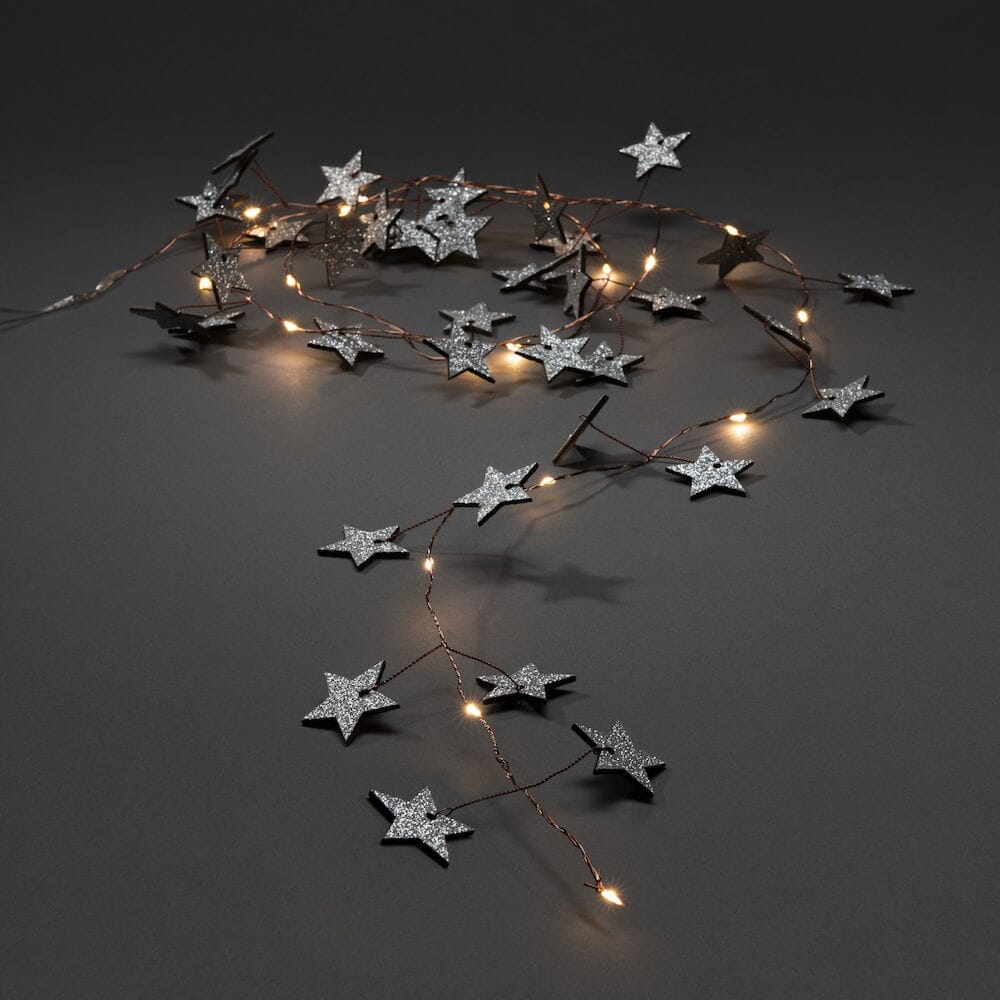 Slynge sølvfargede stjerner med glitter - Trend Collection AS